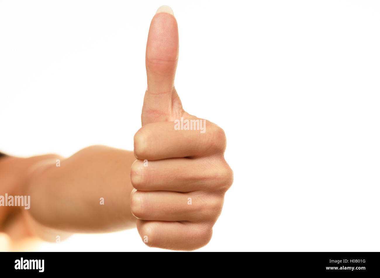 Closeup of female hand showing thumbs up sign against white background ...