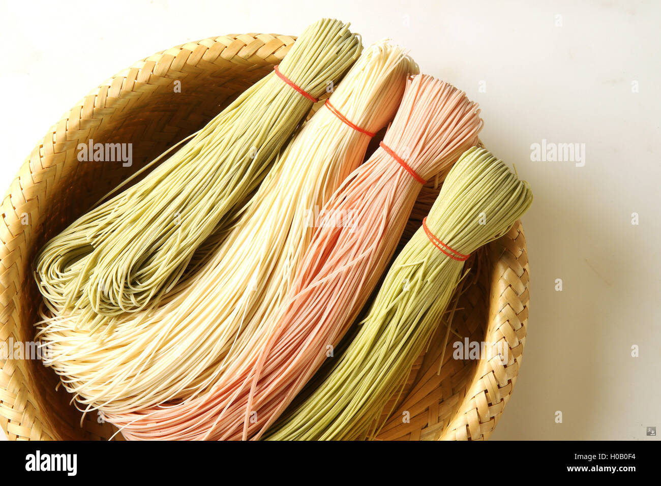 Colorful Chinese spaghetti on bamboo basket in white background Stock ...