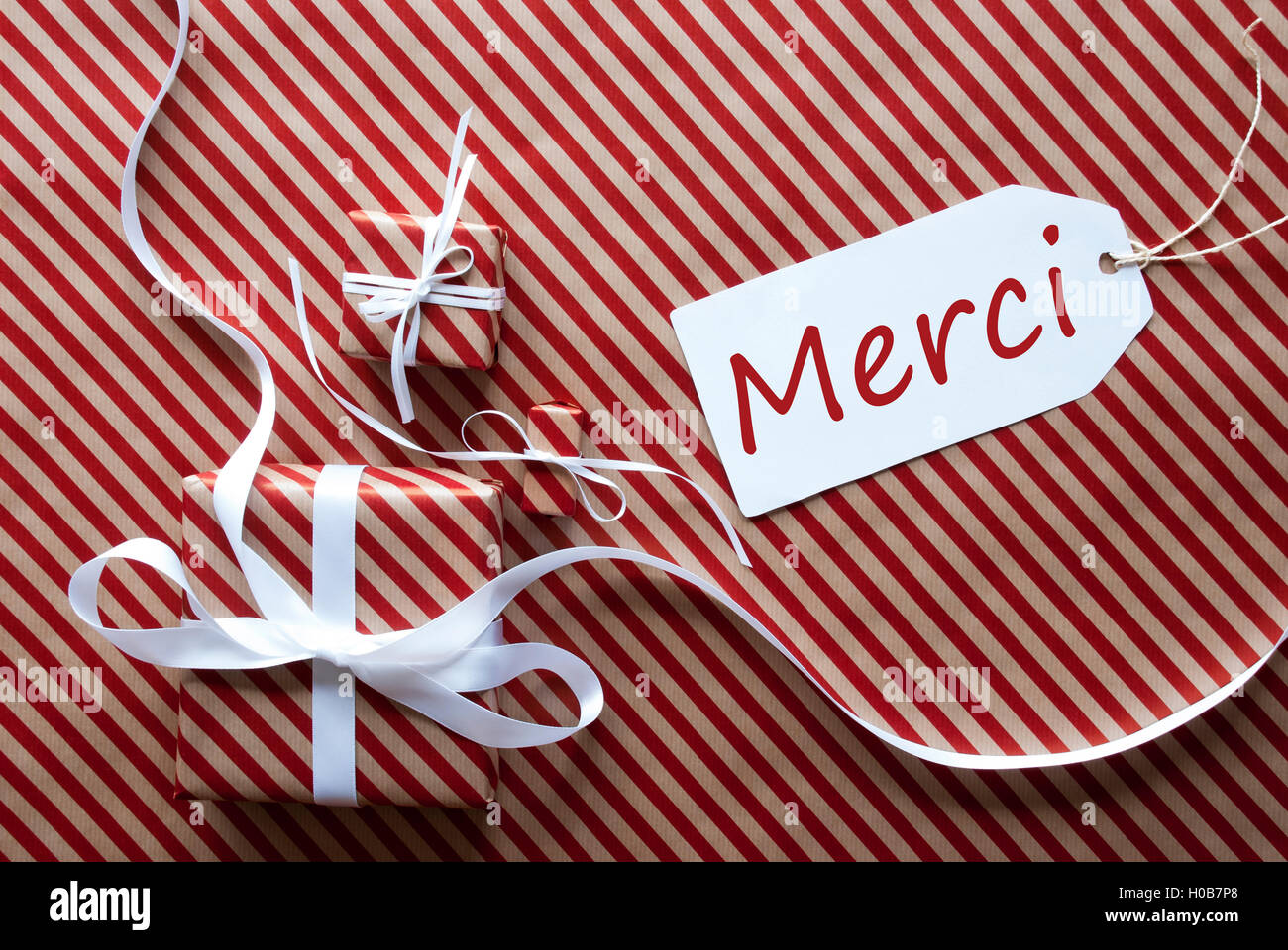 Two Gifts With Label, Merci Means Thank You Stock Photo - Alamy