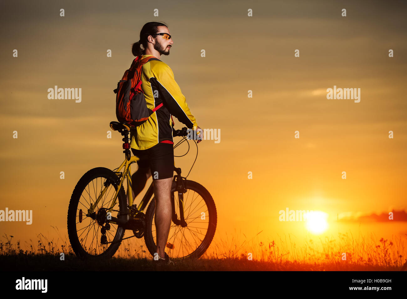 Rear View of a Sporty Man Riding a Bicycle on the Country Road. Healthy ...