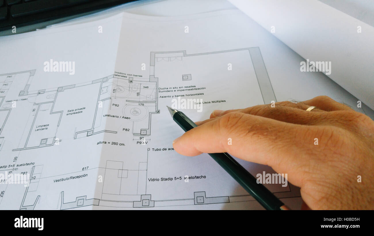 Hand of an architect with a pencil on drawings Stock Photo - Alamy