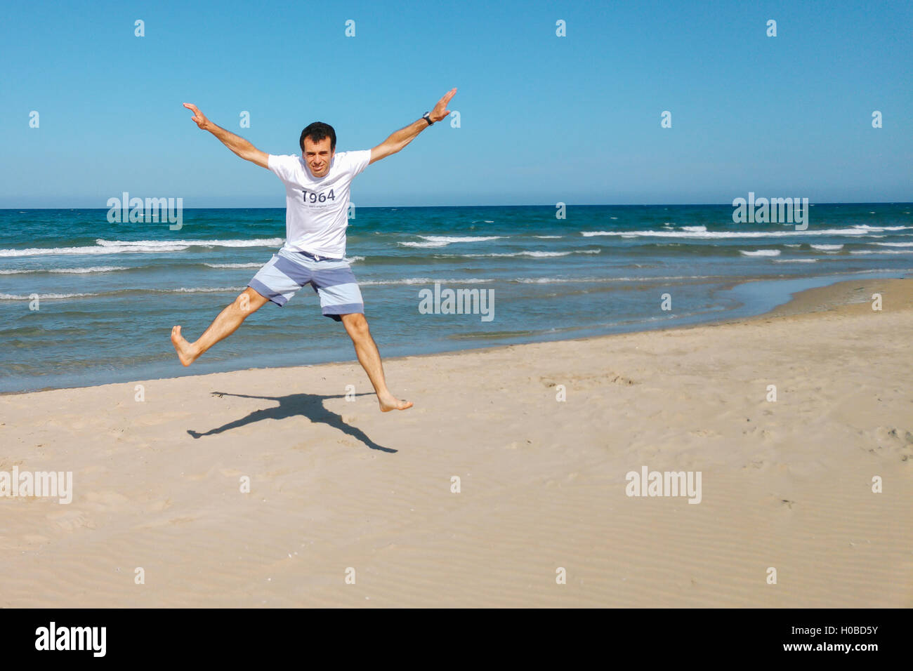 Man jumping on the beach Stock Photo - Alamy
