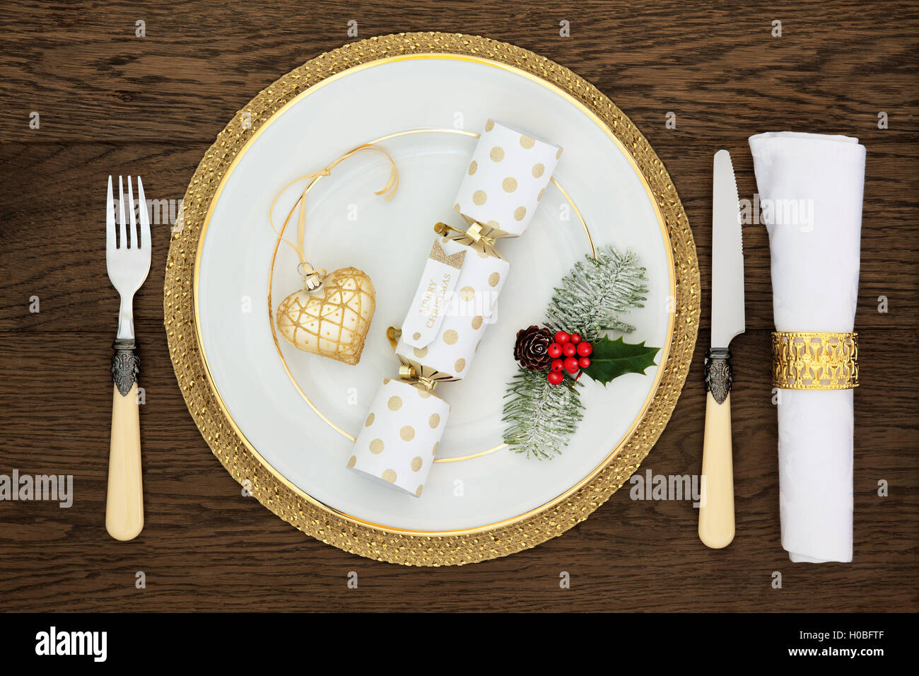 Christmas still life table setting with white porcelain plate, cracker ...