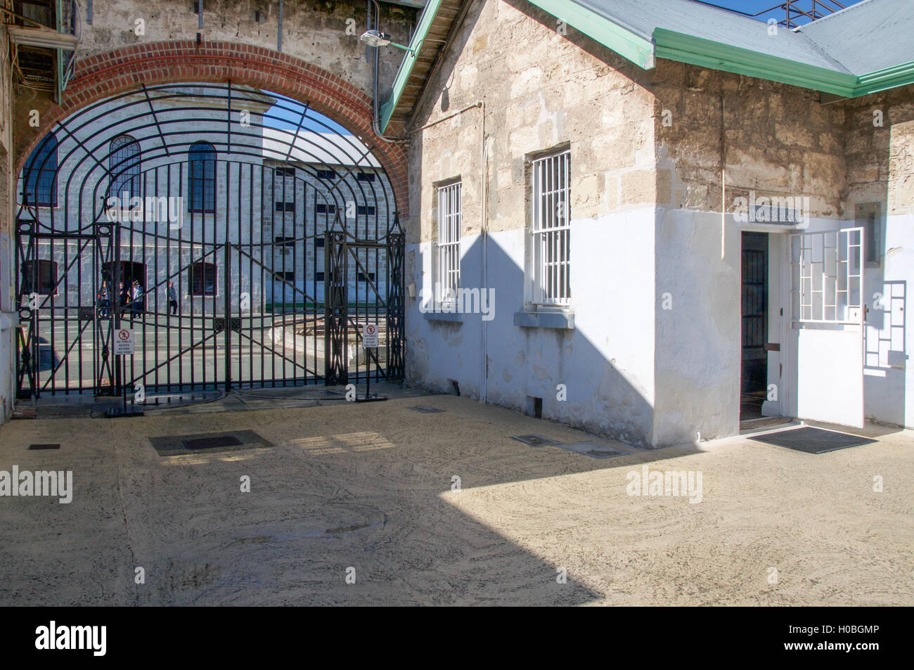 Outdoor courtyard entrance with arched gateway and limestone brick ...