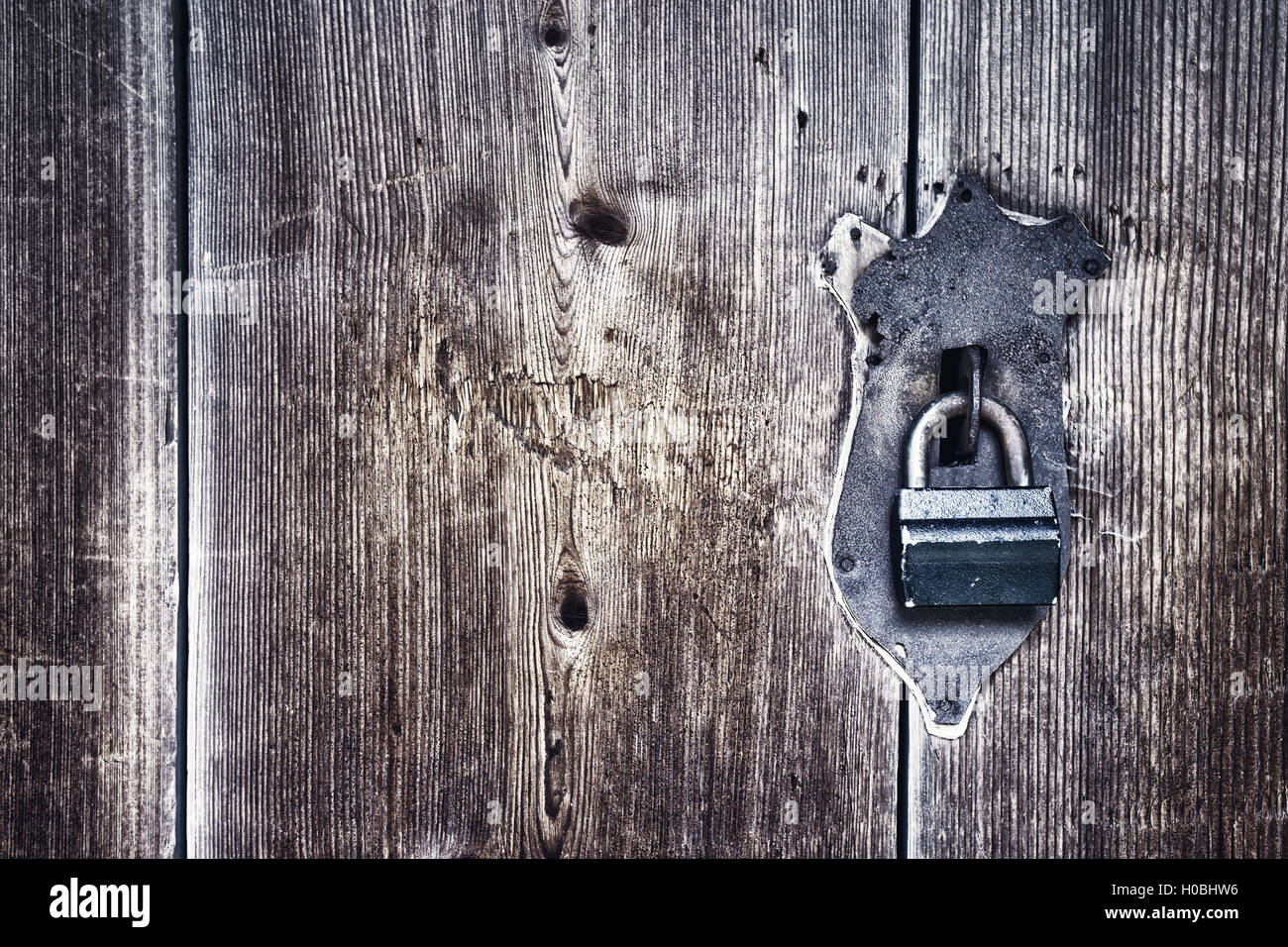 Iron lock on a wooden door in the wall Stock Photo - Alamy