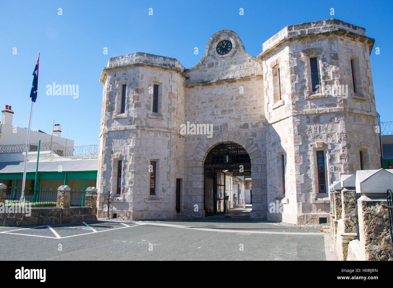 Front view of the historic limestone Fremantle Prison with arched entry ...