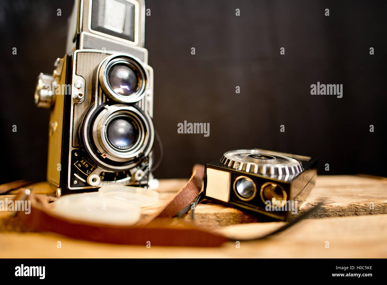 old twin-lens reflex camera with light meter on the black background ...