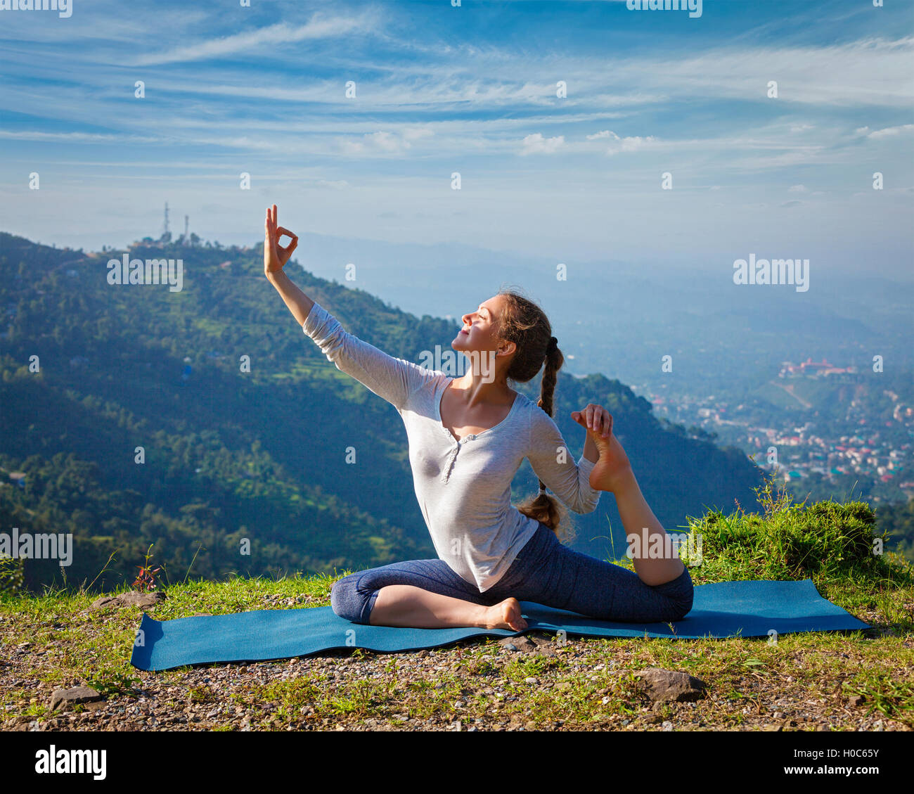 Sorty fit woman doing yoga asana outdoors in mountains Stock Photo - Alamy