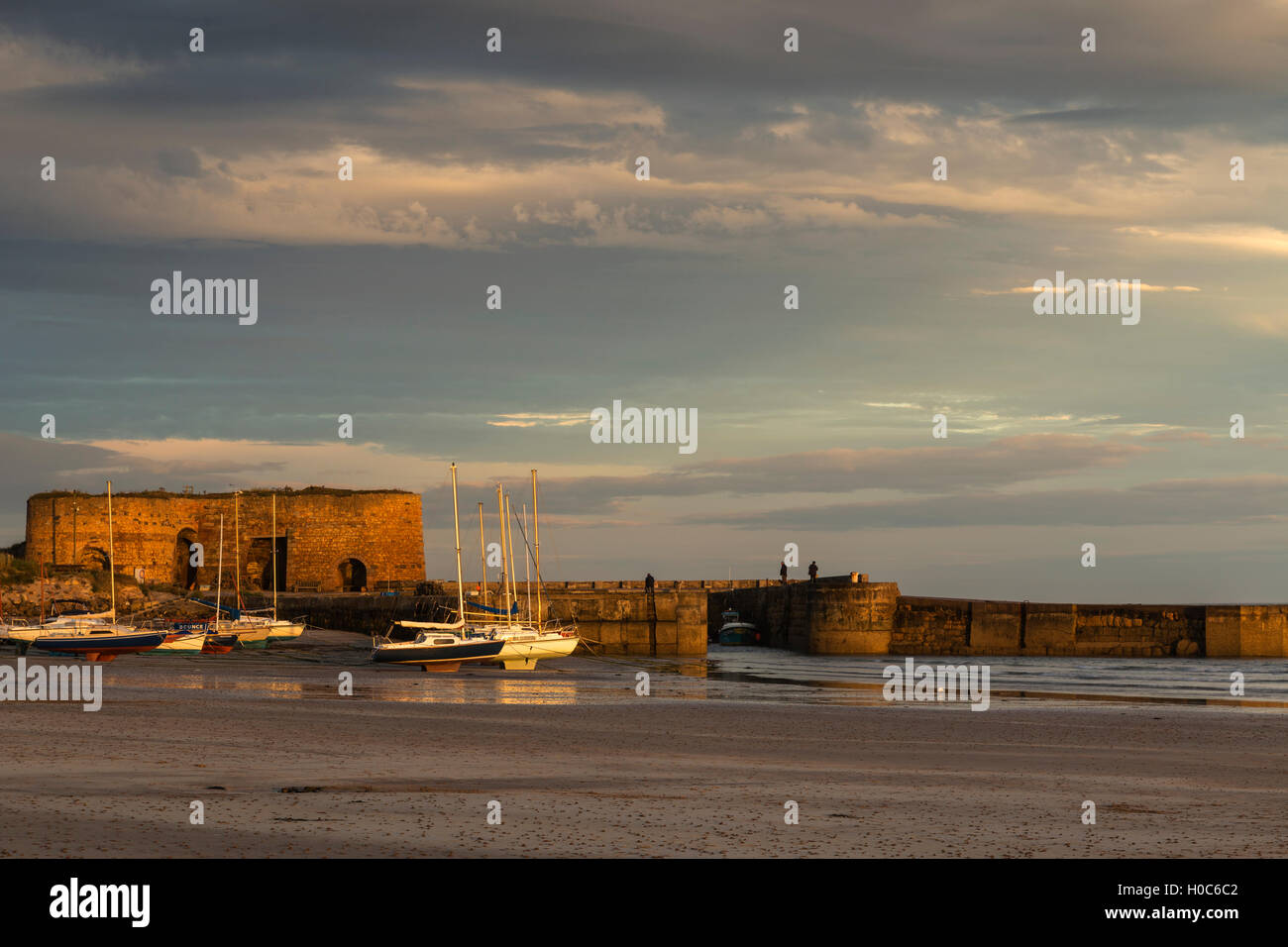Beadnell Harbour Illuminated by Setting Sun Stock Photo - Alamy