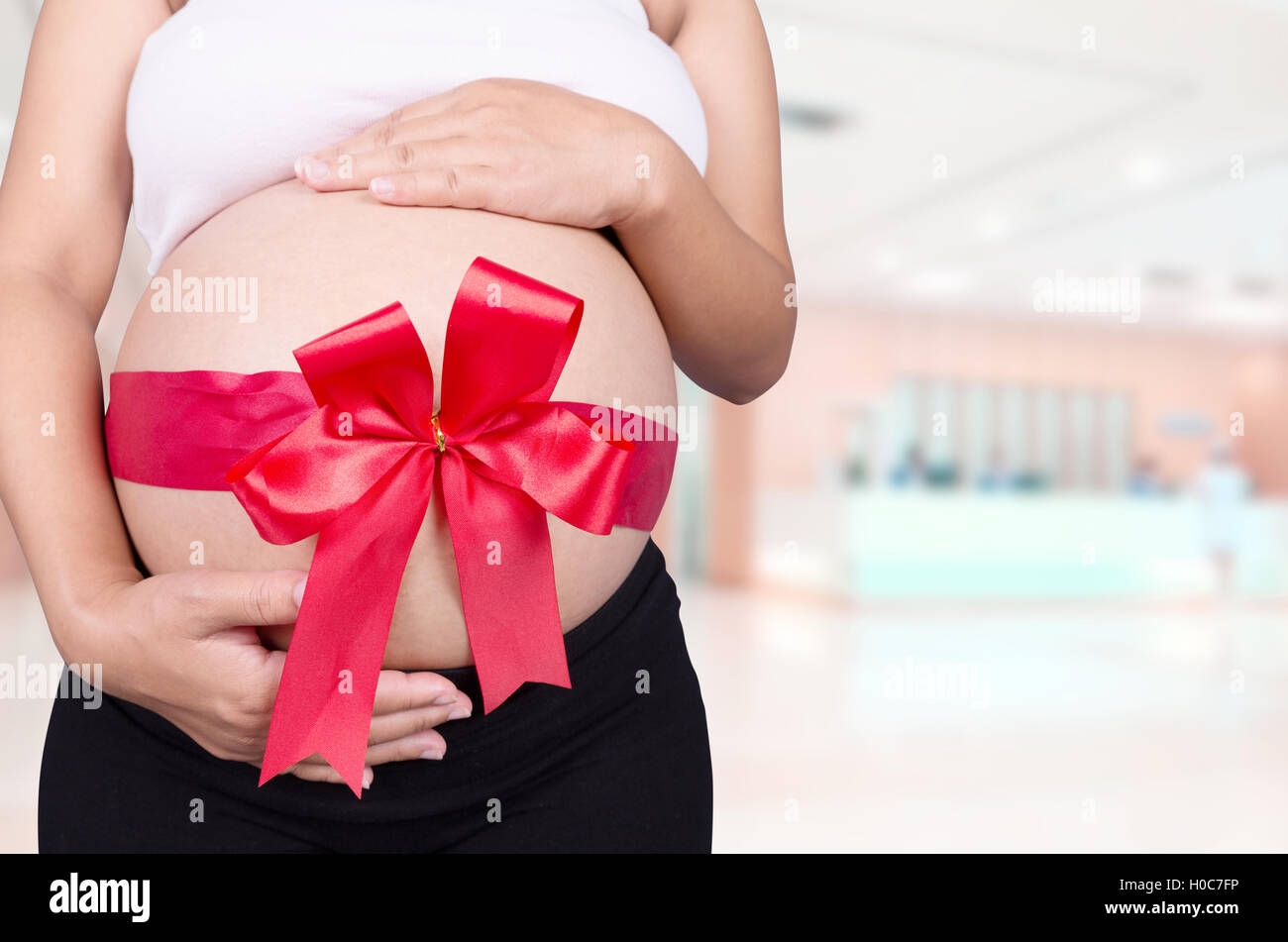 Pregnant belly pink ribbon hi-res stock photography and images - Alamy