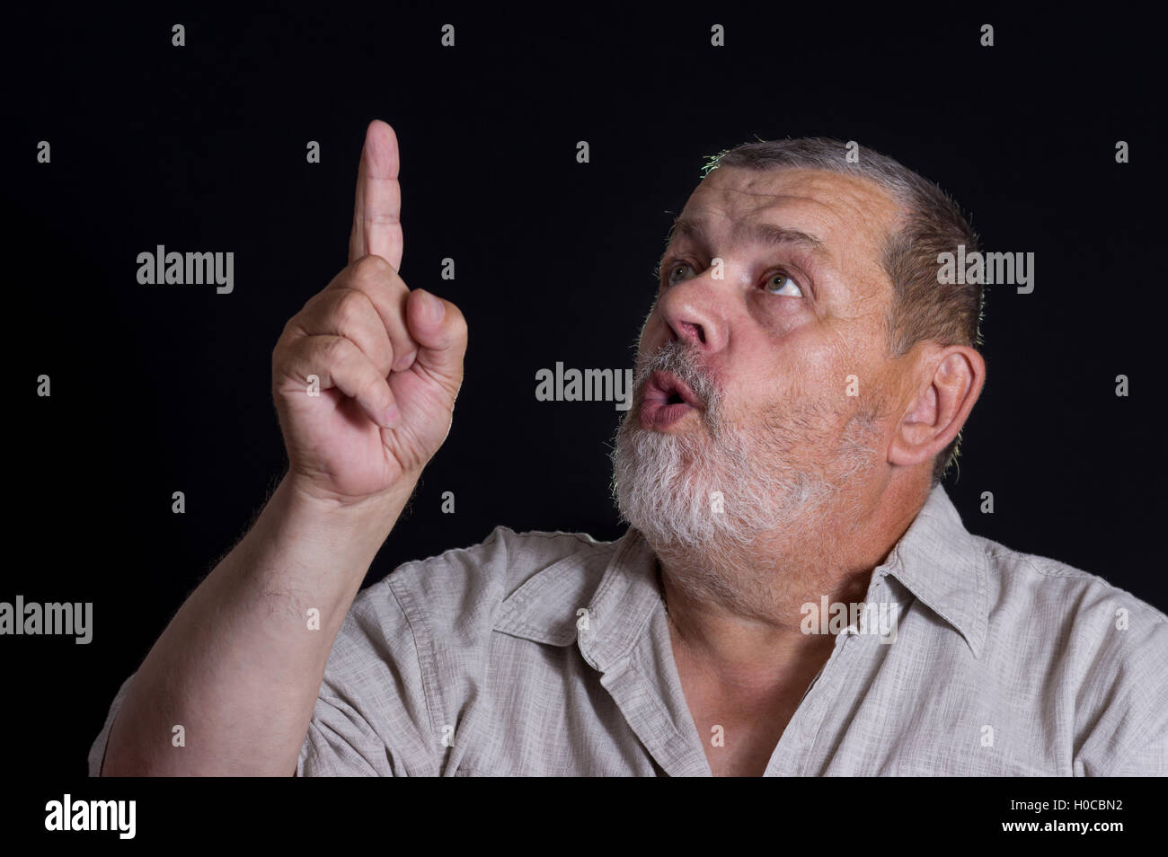 Very emotional portrait of senior man pointing forefinger up Stock ...