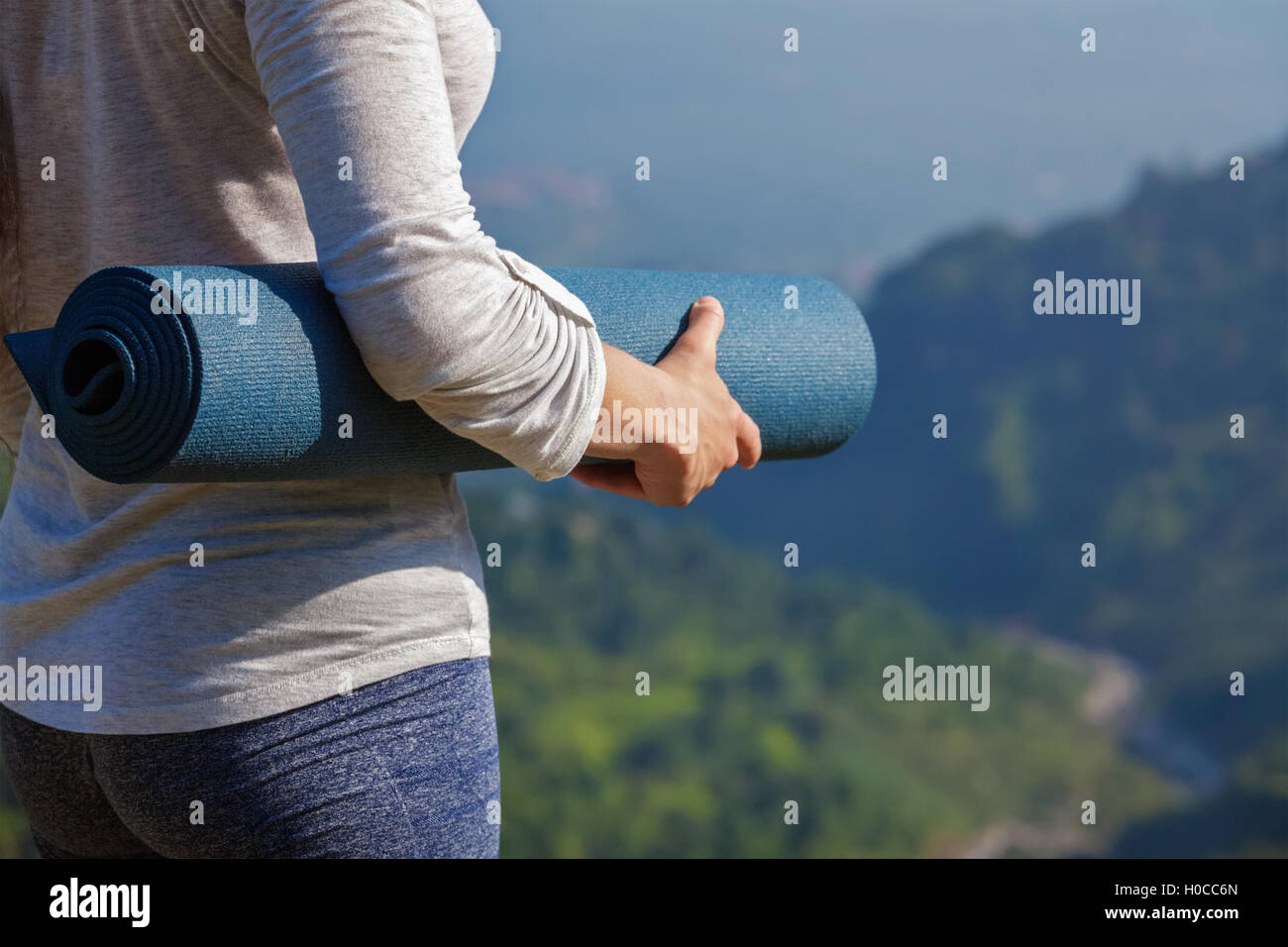 Woman standing with yoga Stock Photo - Alamy