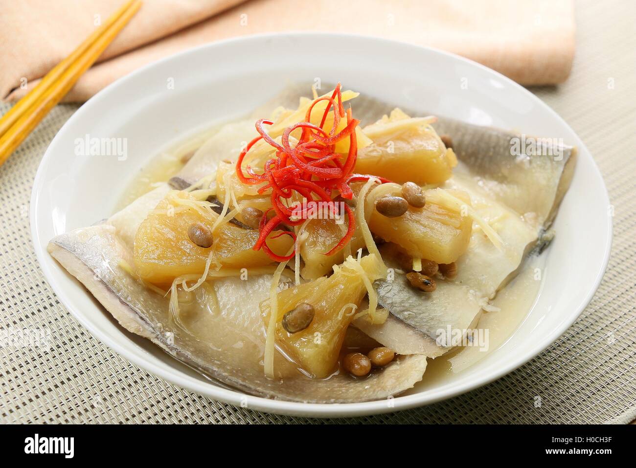 Sauce of milkfish with braised pineapple and sliced chili on white ...