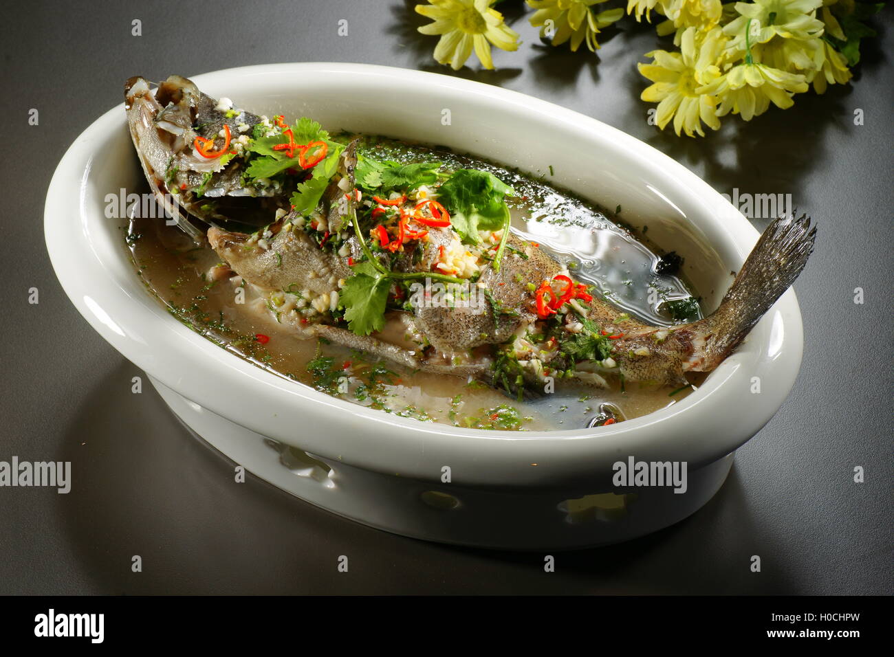 Special braised grouper fish with soup in chinese style in white big ...