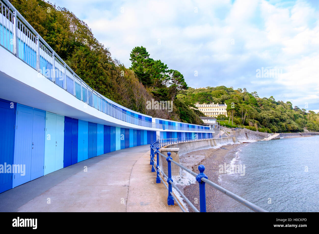 Beautiful row of colorful blue beach huts by the sea at Meadfoot Bay in ...