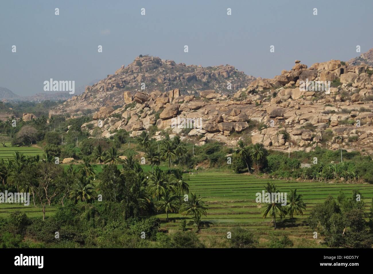 Landscape in Hampi, Karnataka. Granite mountain and rice fields ...