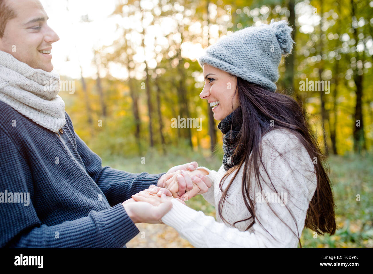 Beautiful young couple holding hands. Sunny autumn nature Stock Photo ...