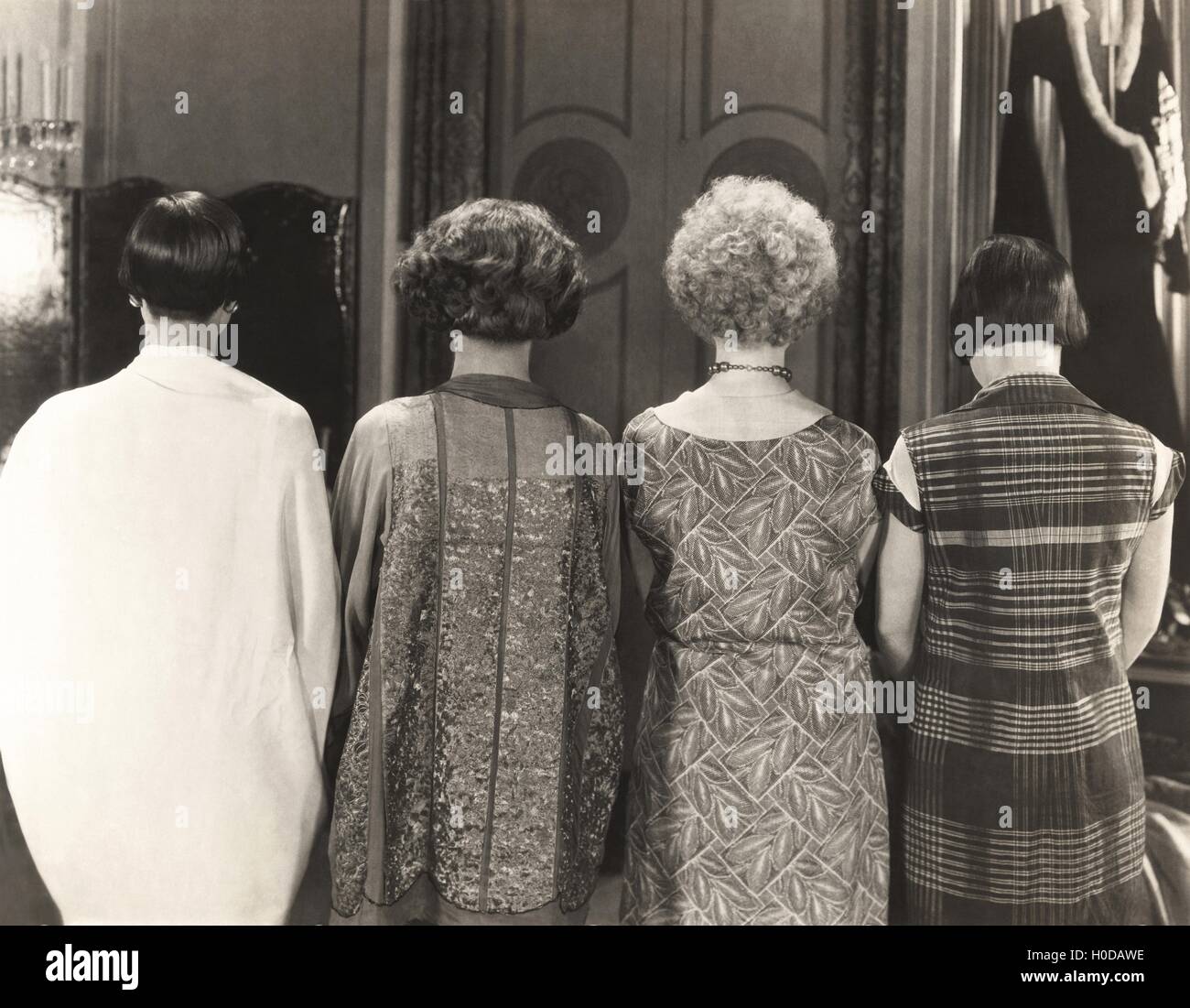 Rear view of four women standing in a row Stock Photo - Alamy