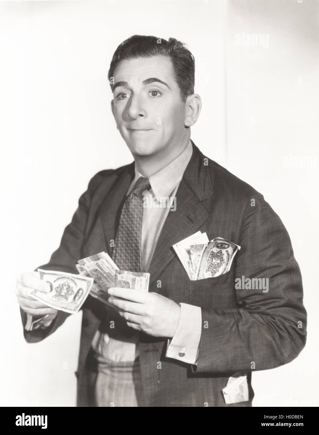 Wad of cash and man hi-res stock photography and images - Alamy