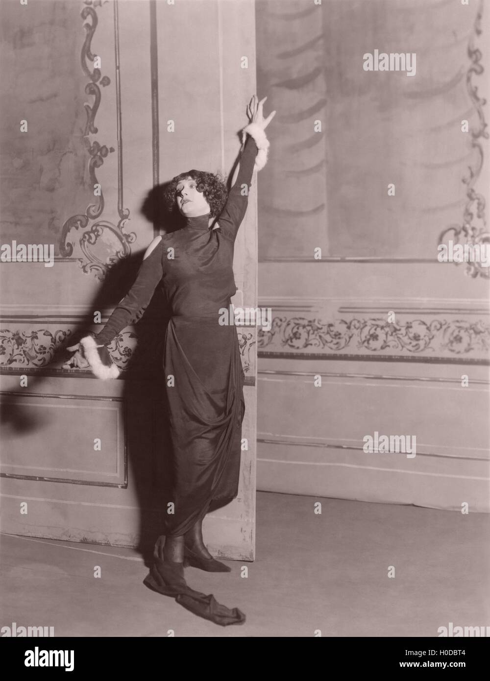 Woman standing in dramatic pose Stock Photo - Alamy