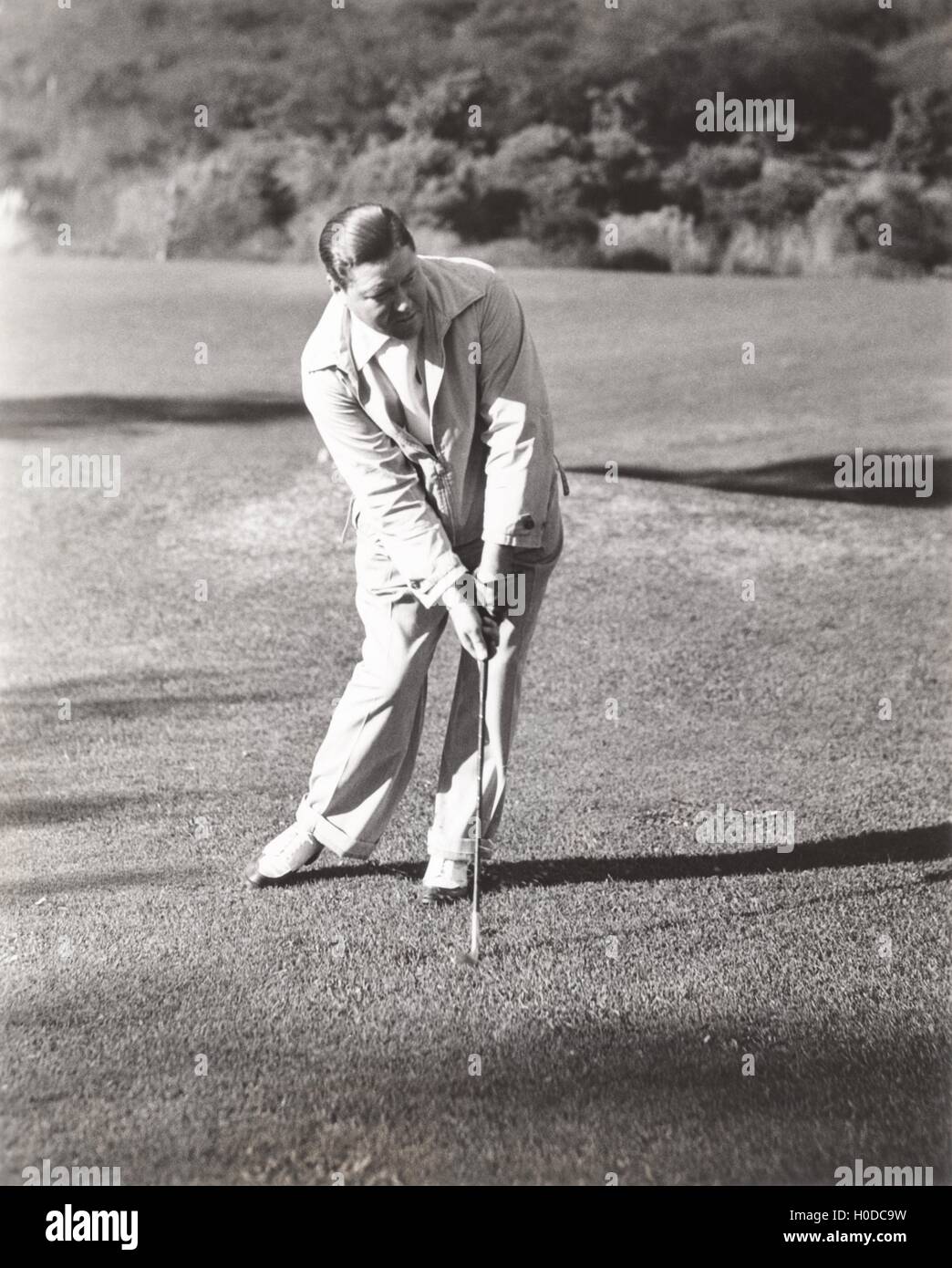 Man playing golf at country club Stock Photo - Alamy