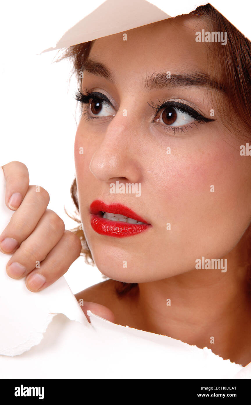 A the face of a beautiful young woman showing trough a hole in the ...