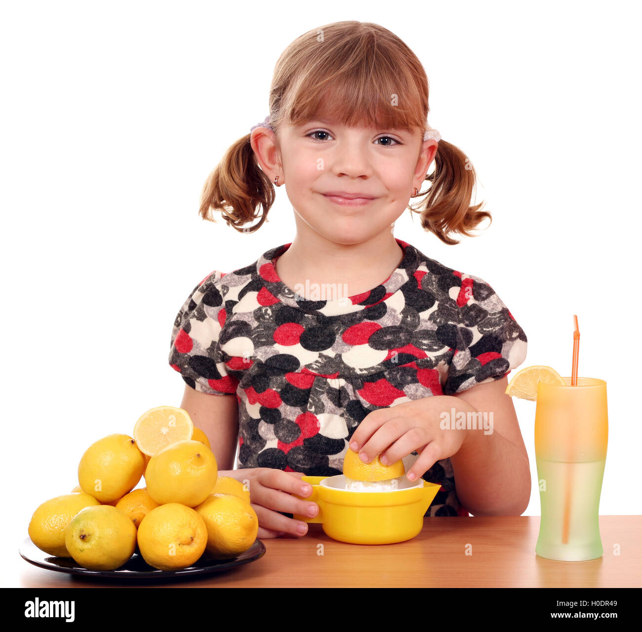 happy little girl make lemonade Stock Photo - Alamy