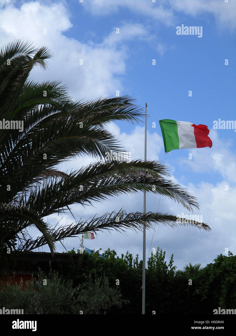 Italian flag flying, blue sky background Stock Photo - Alamy