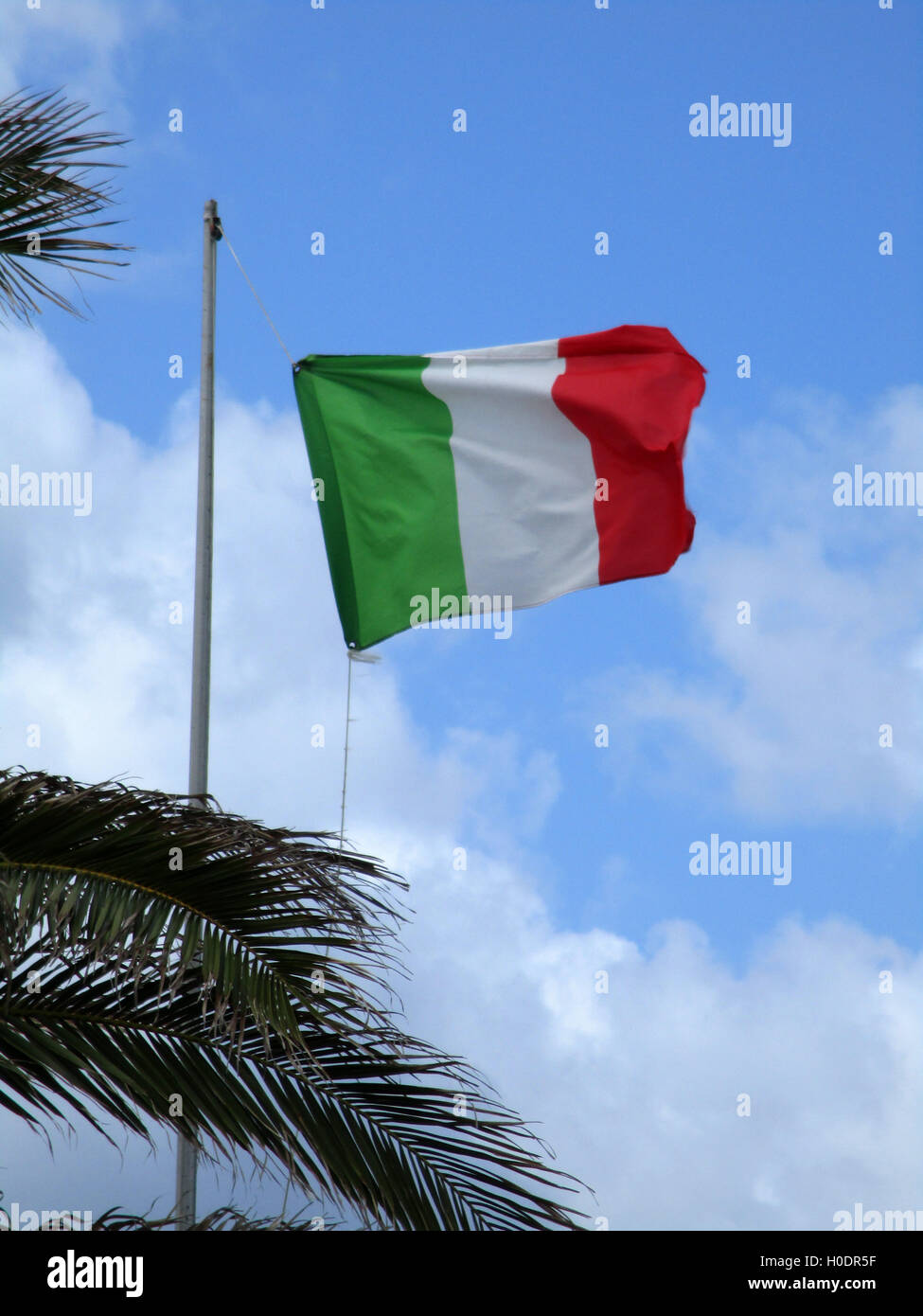Italian flag flying, blue sky background Stock Photo - Alamy