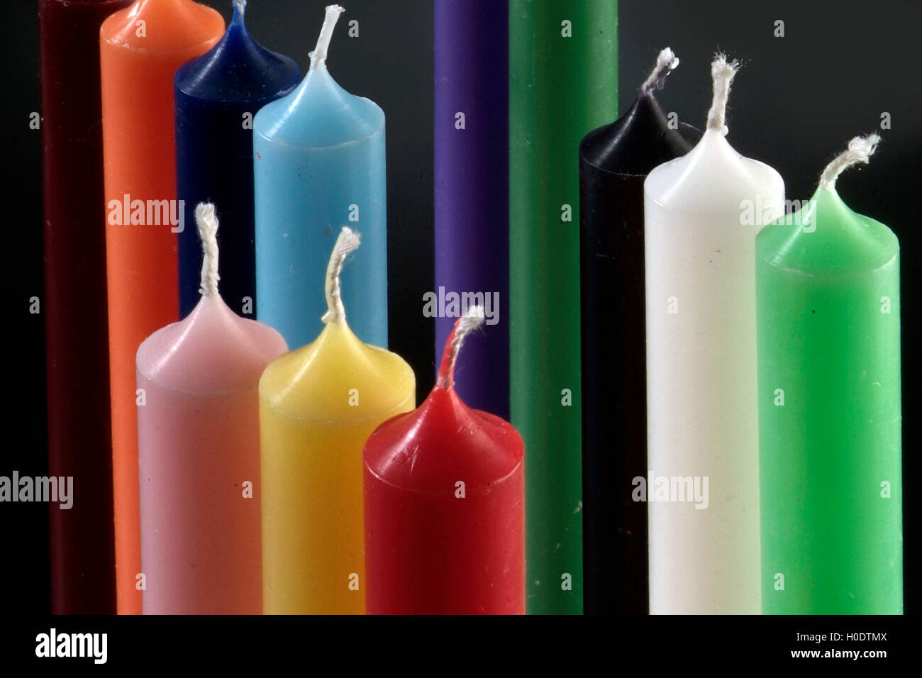 group of colorful cylindrical candles on a black background Stock Photo ...
