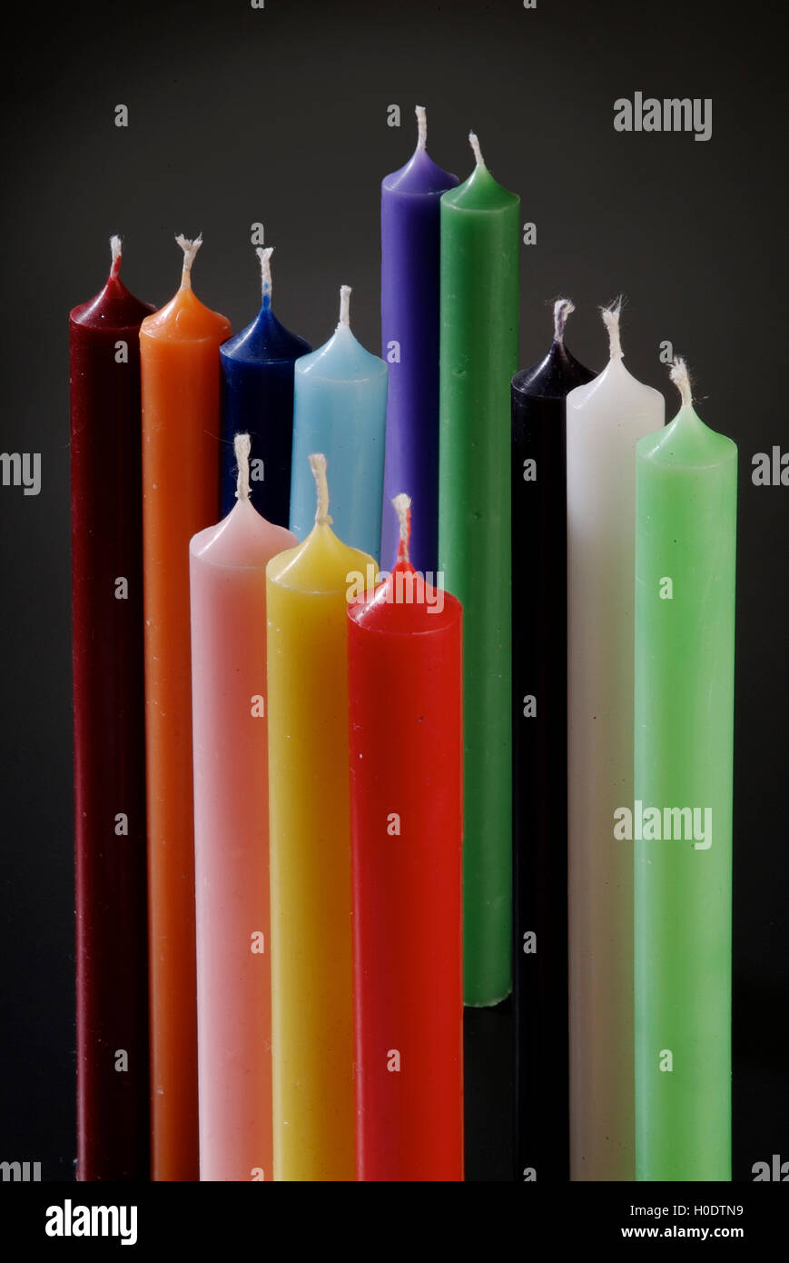 group of colorful cylindrical candles on a black background Stock Photo ...