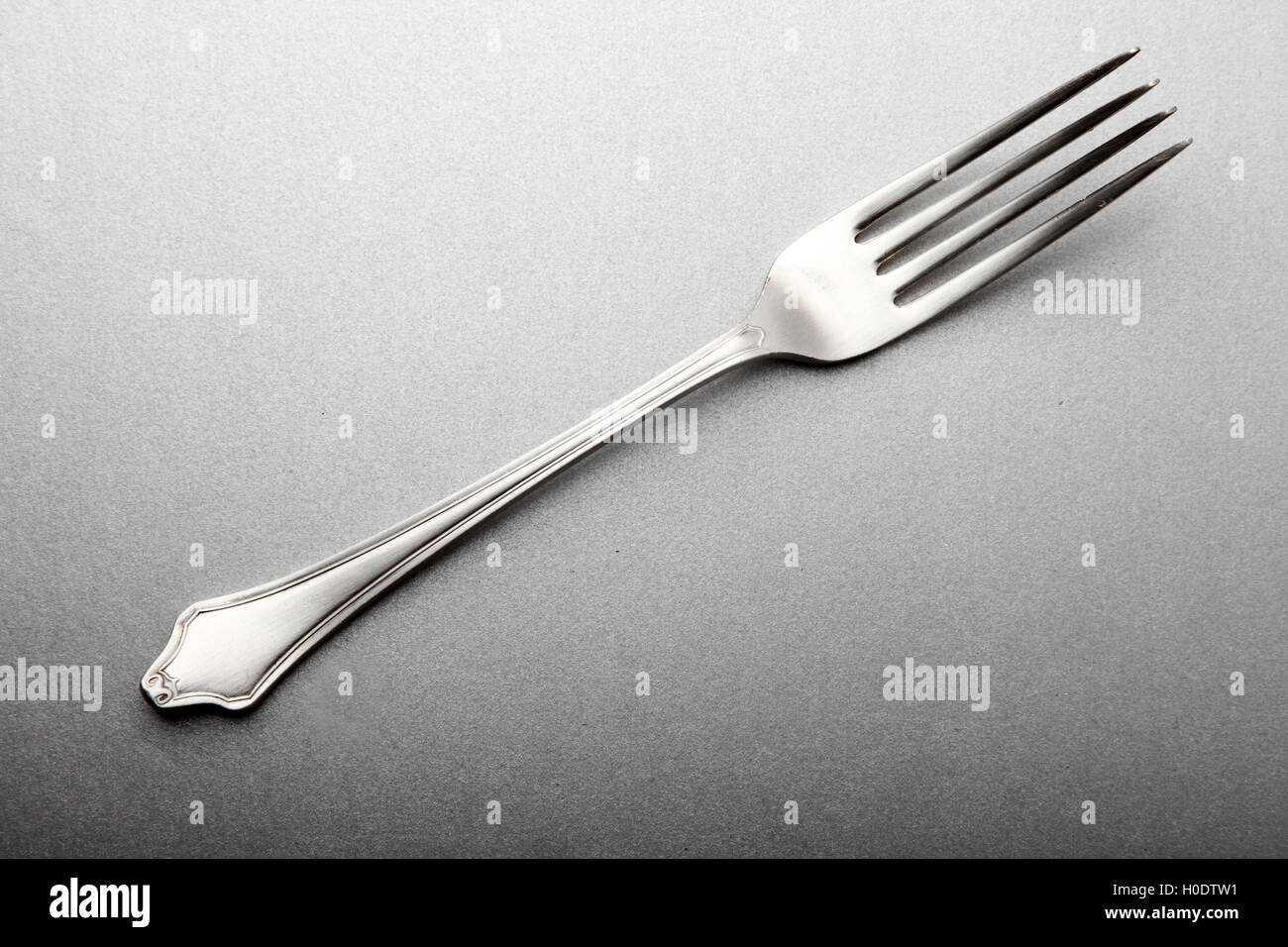 elegant steel fork engraved on the handle, on white silver Stock Photo ...