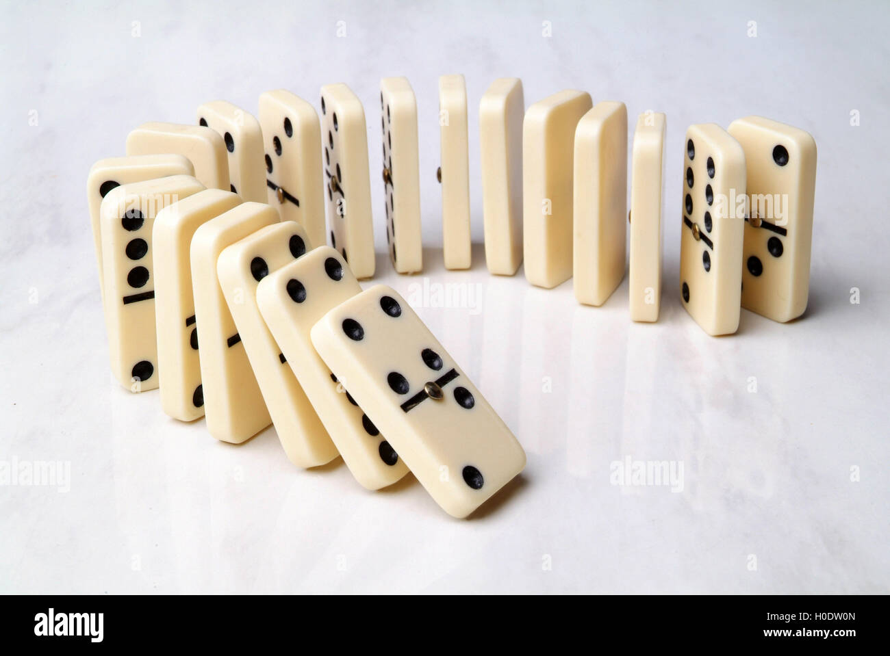 group of domino tiles in a semicircle shape on a neutral background ...