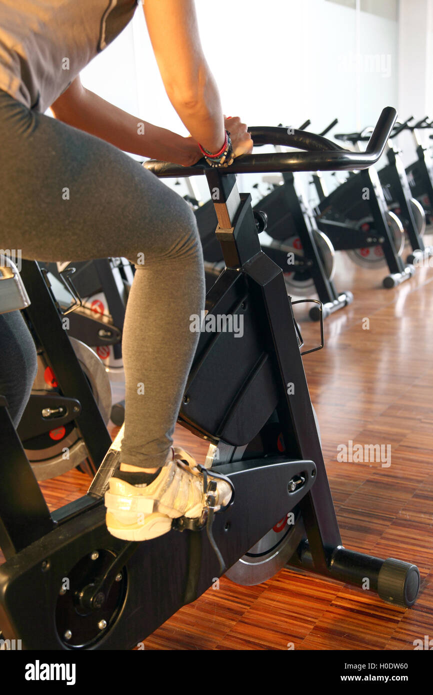 gym-athlete woman on exercise bike ride Stock Photo - Alamy