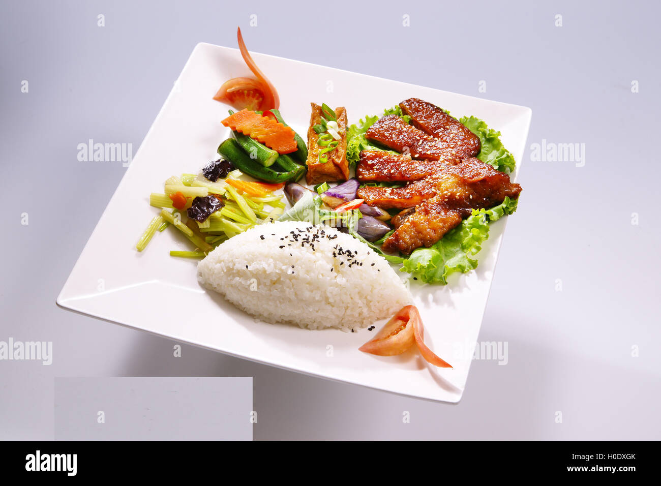 Braised ribs rice with vegetable on white plate in white background ...