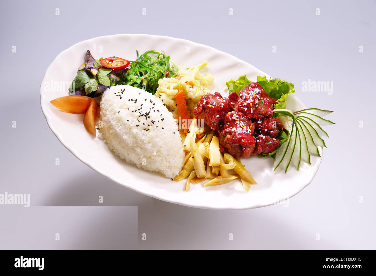 Red yeast rice ribs with vegetable on white plate in white background ...