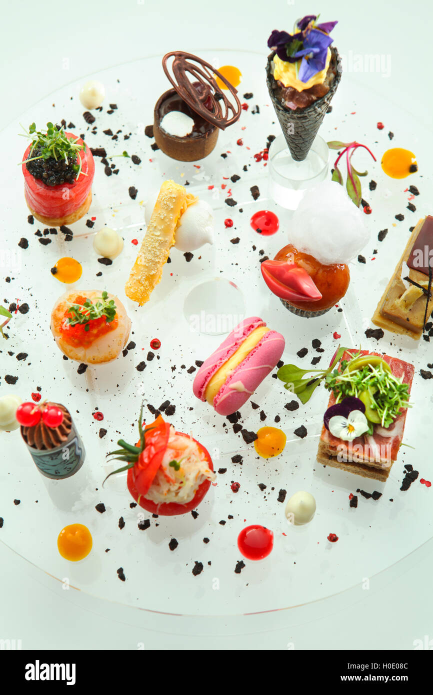 Cake buffet with muffin, chocolate, candy, cheese and cream on white ...