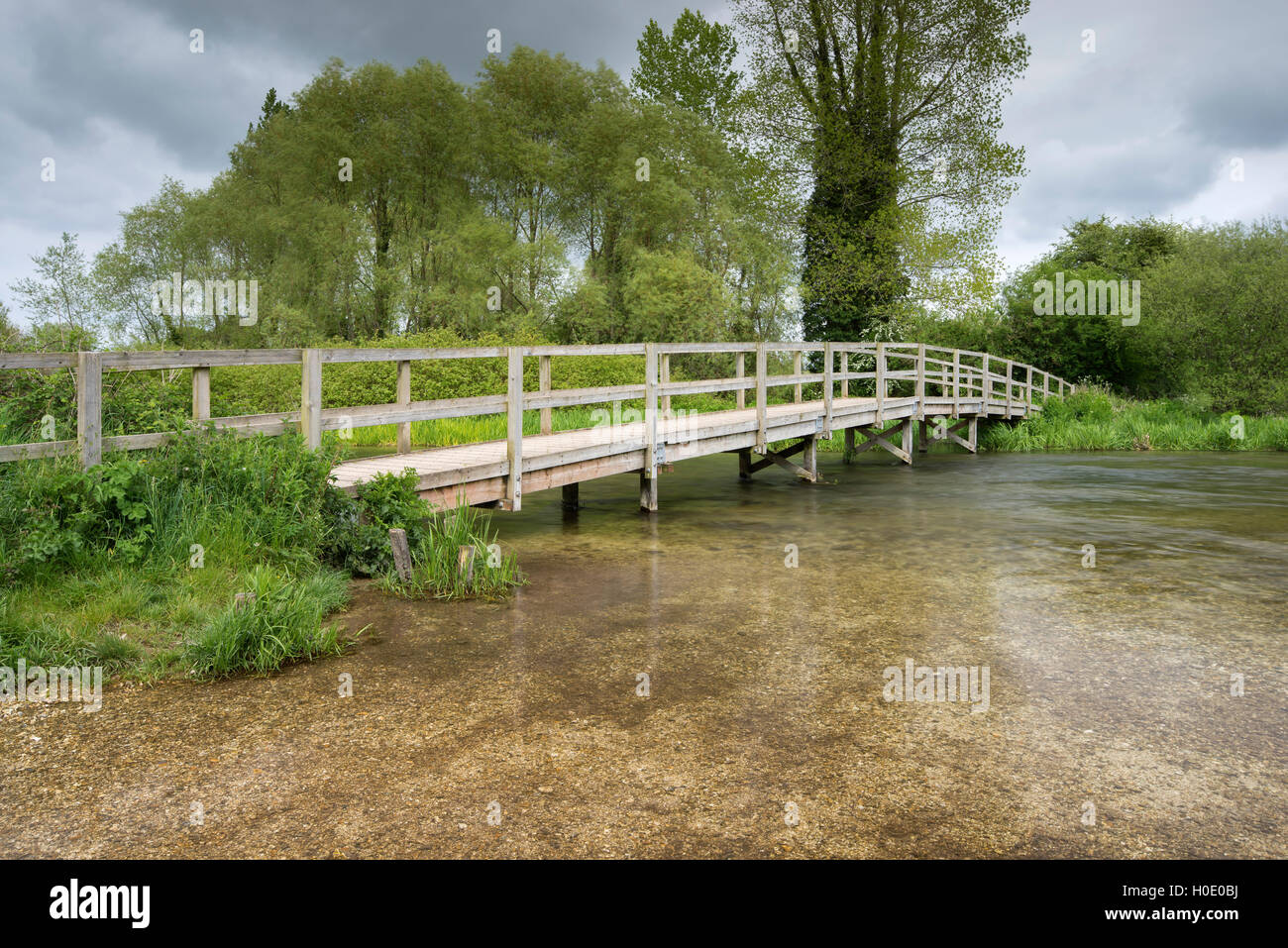 A footbridge for the Monarch's Way spanning the River Test at Houghton ...