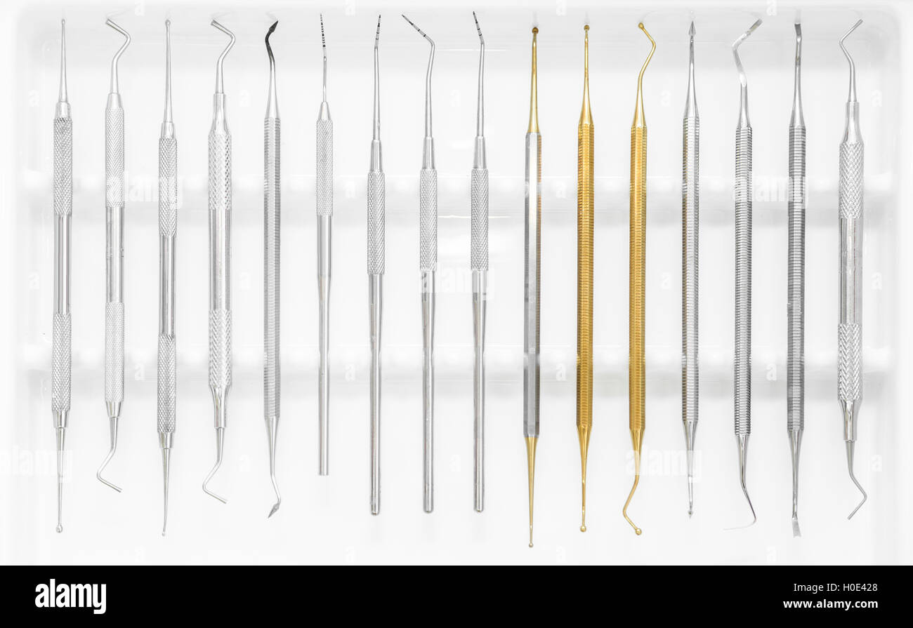 Tools for dental treatment on white background Stock Photo - Alamy