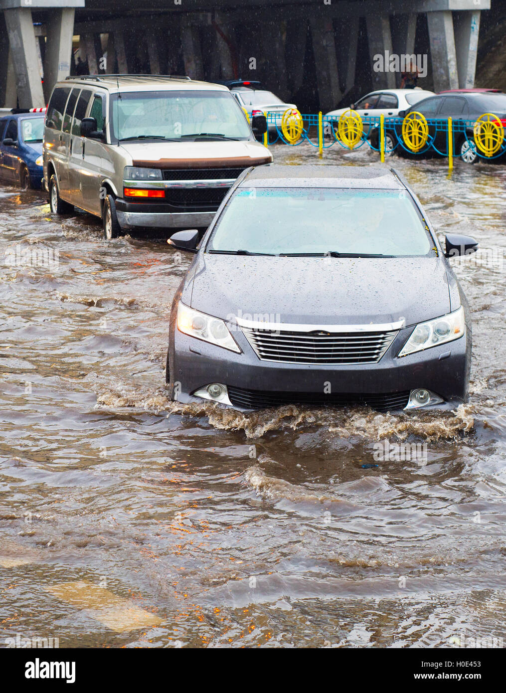 Car traffic in a heavy rain on a flooded city road Stock Photo - Alamy
