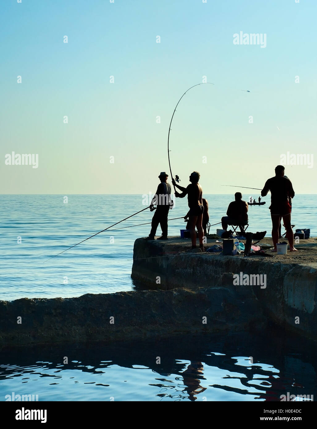 Silhouette fisherman on pier sunset hi-res stock photography and images ...