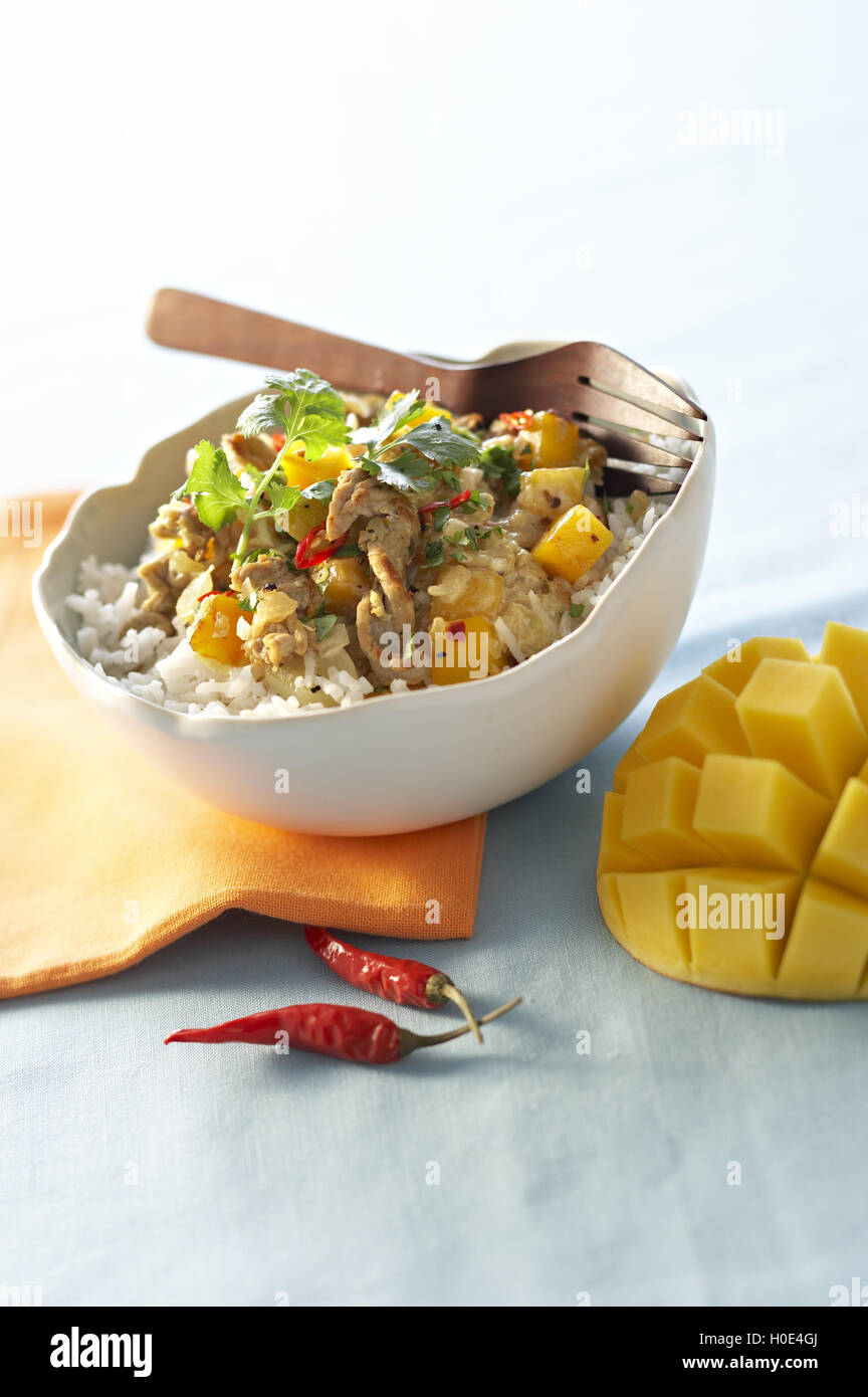 Spicy veal sauteed with mango on white bowl with dried chili Stock ...