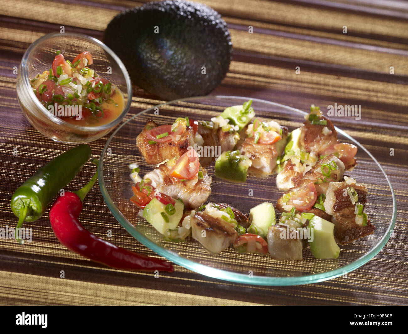 Lardelles veal brisket, tomato rougail with chili and avocado on glass ...