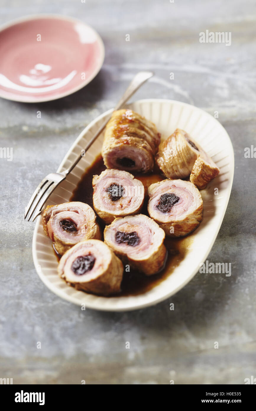 Veal rolled with bacon and prunes in plate in restaurant Stock Photo ...