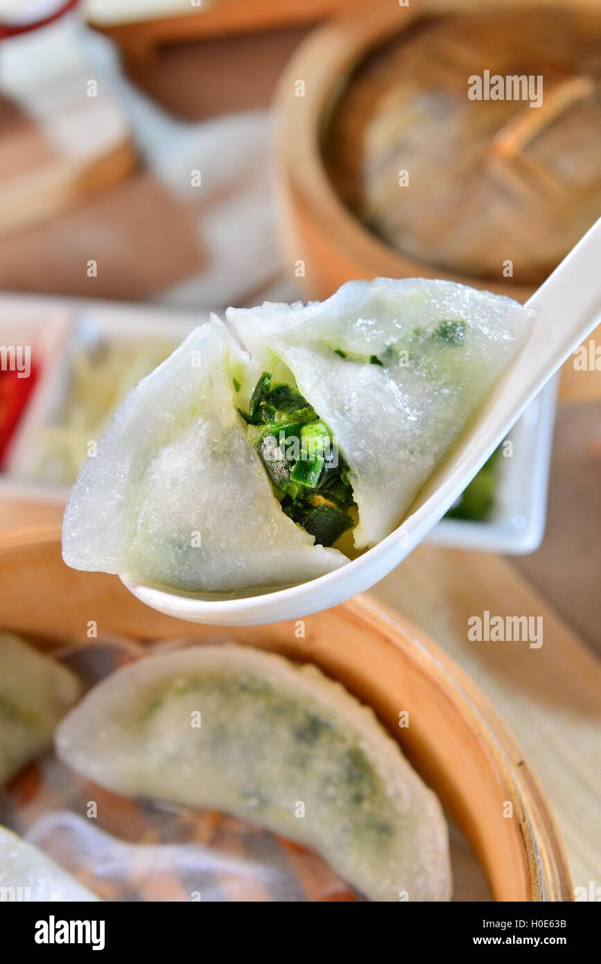Crystal chives dumpling dishes sinks on white spoon Stock Photo - Alamy