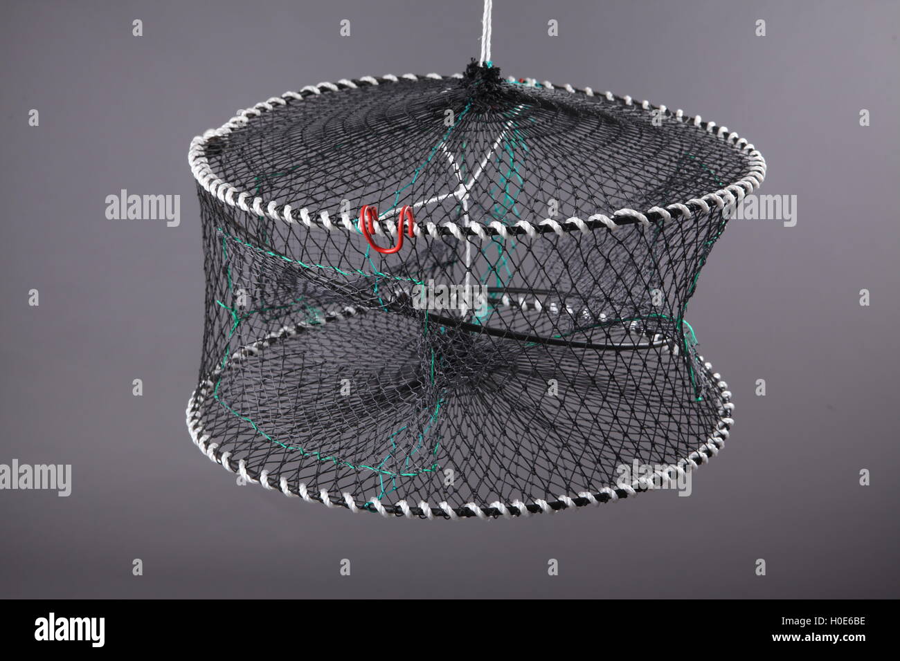 Harvest gear of round grid for fishing tackle on grey background Stock ...