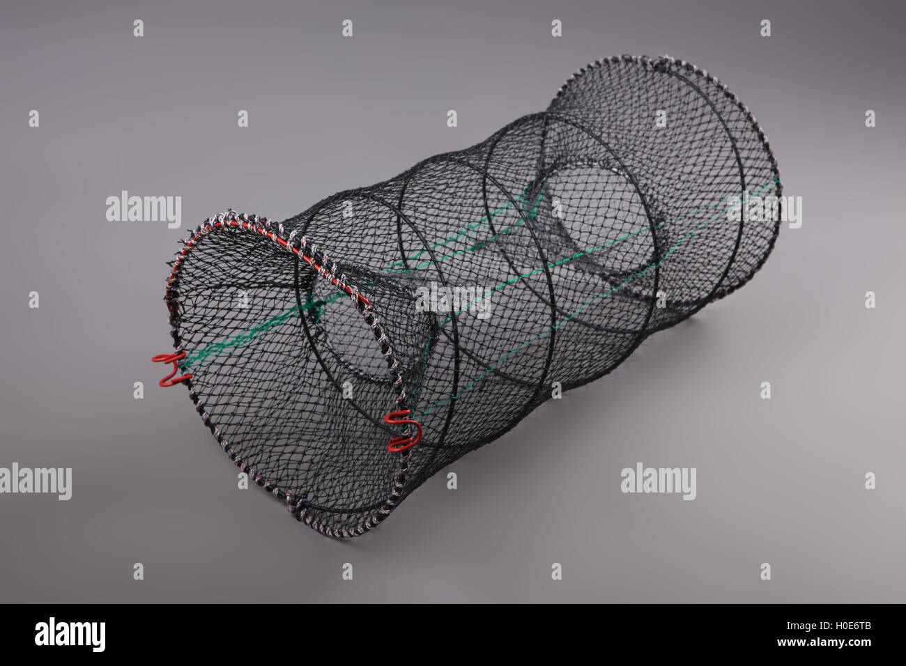 Harvest gear of round grid for fishing tackle on grey background Stock ...