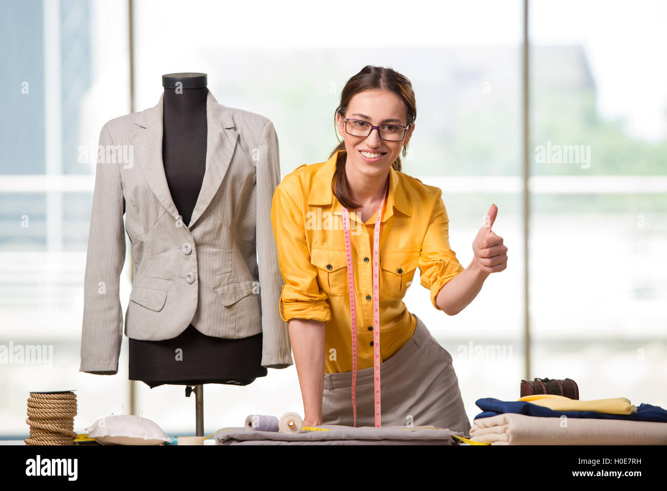 Woman tailor working on new clothing Stock Photo - Alamy
