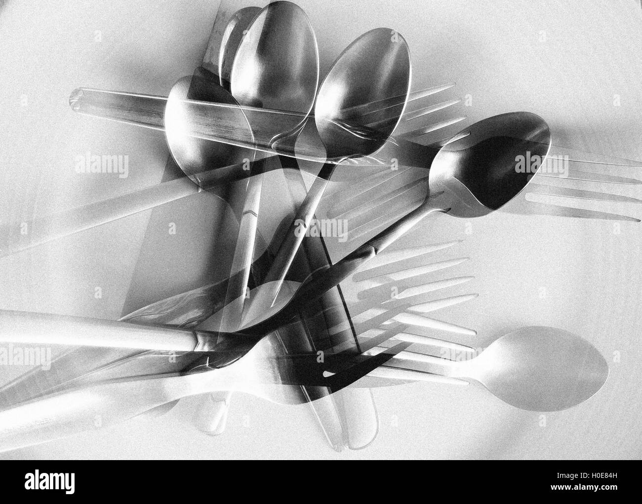 Double exposure in the same frame of forks and spoons Stock Photo - Alamy