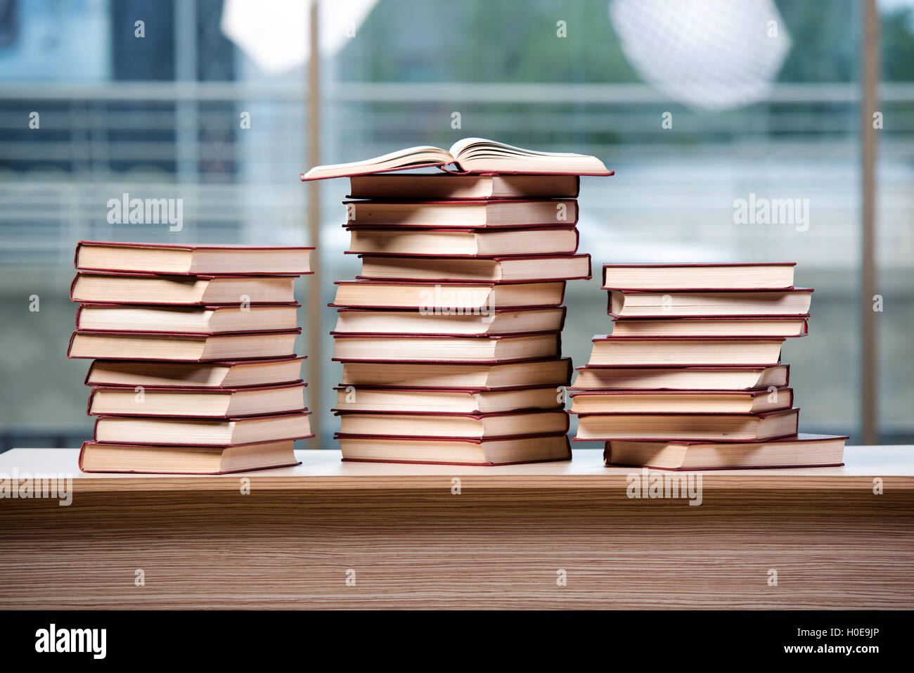 Stack of books arranged the office desk Stock Photo - Alamy